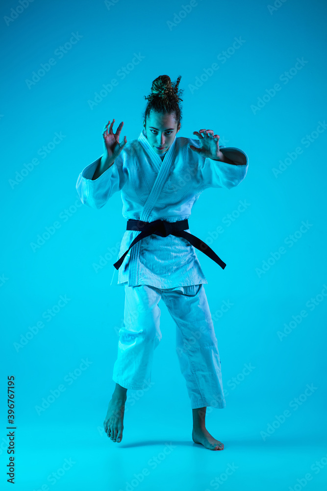 Attack Professional Female Judoist In White Judo Kimono Practicing And Training Isolated On