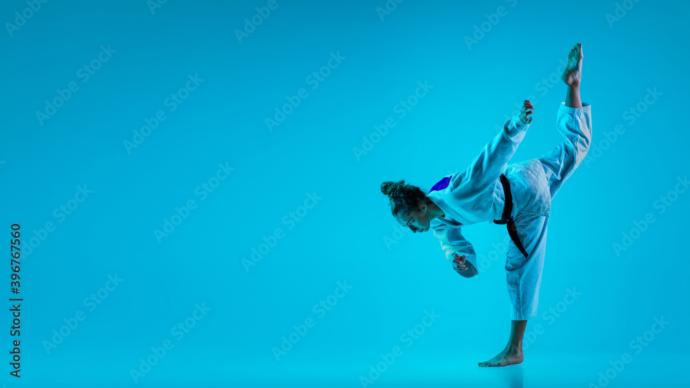 Concentration. Professional female judoist in white judo kimono ...