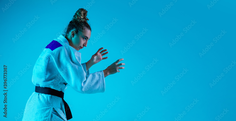 View from side. Professional female judoist in white judo kimono ...