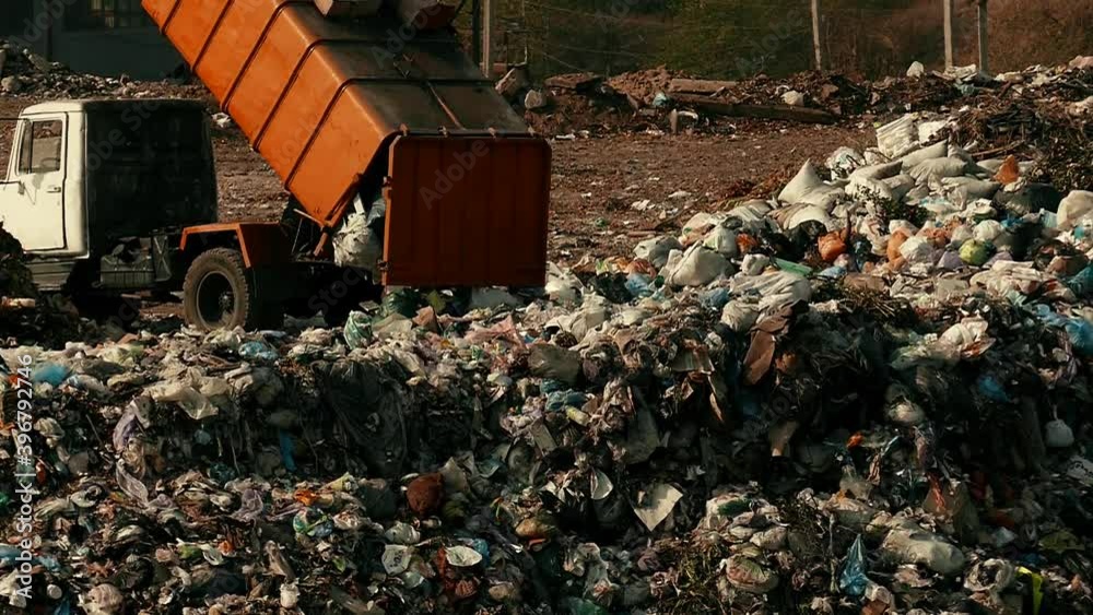 Garbage bags are poured out of the garbage truck. Damage to the ...