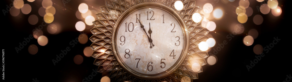 Golden New Year clock in a beautiful bokeh background. Festive ...