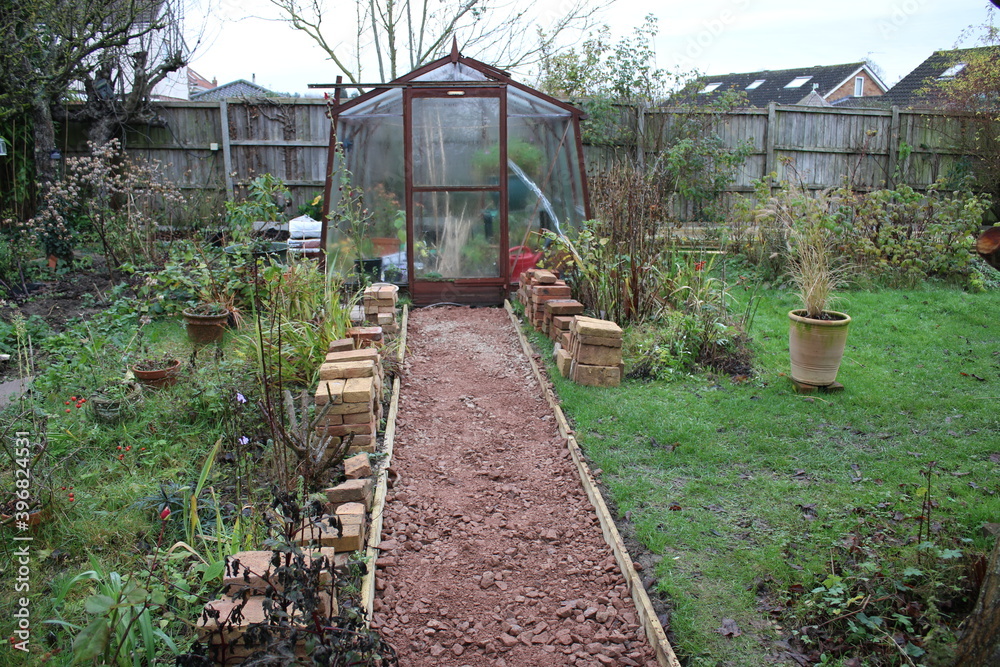Landscape of path way built to glass greenhouse through grass lawn and ...