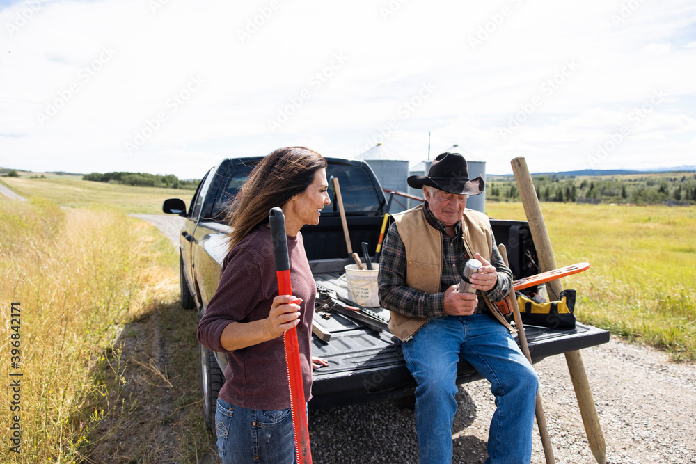 Father and daughter ranchers taking a break at sunny pickup truck Stock ...