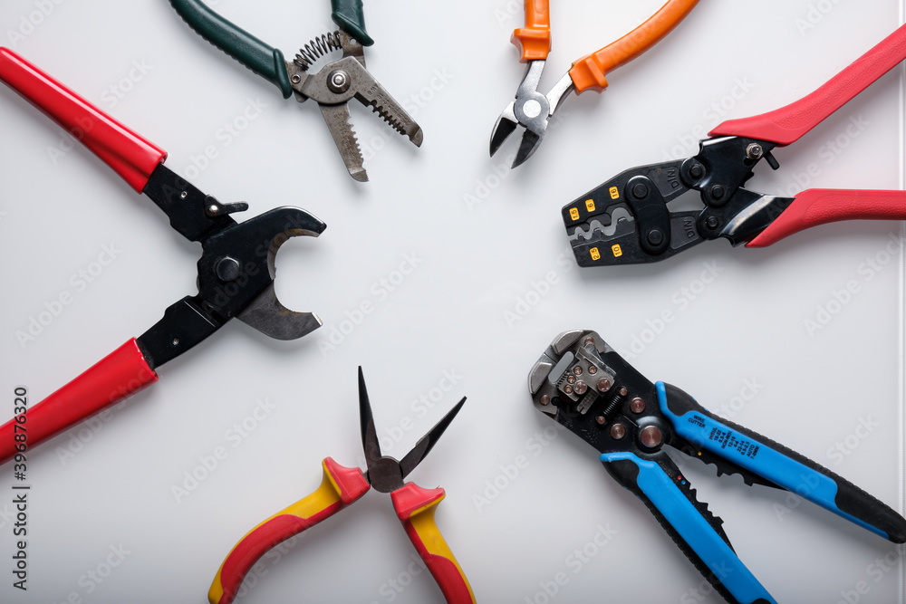 Wire cutter, stripper, pliers for different cable types. Red, green ...