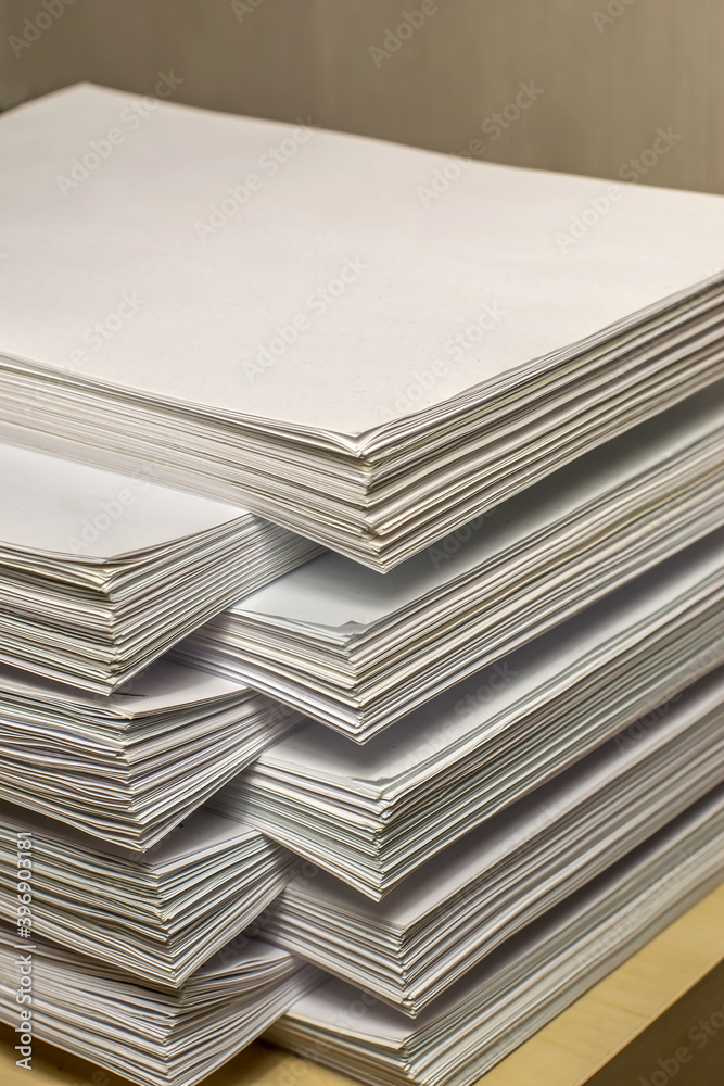 bundles bales of paper documents. stacks packs pile on the desk in the ...