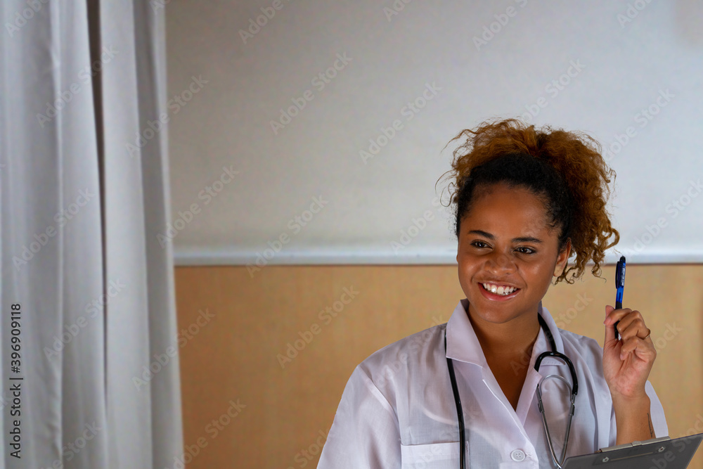 Young attractive female African American doctor or internist in white ...