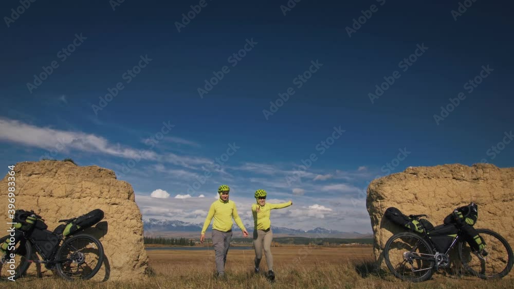 The man and woman travel on mixed terrain cycle bike touring with ...