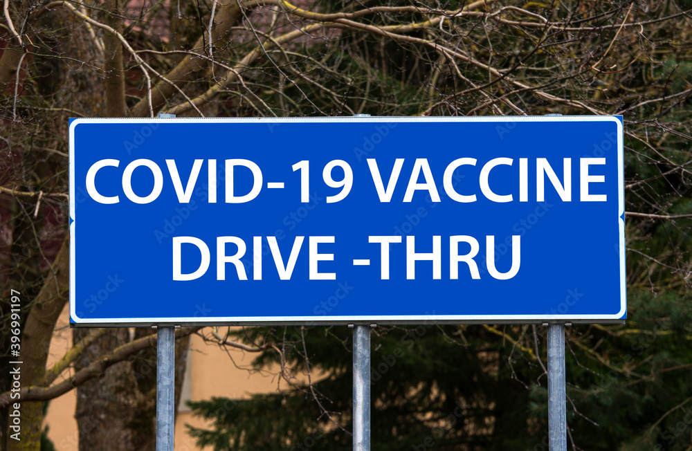 Covid-19 vaccine drive-thru concept. Blue road sign pointing to drive ...