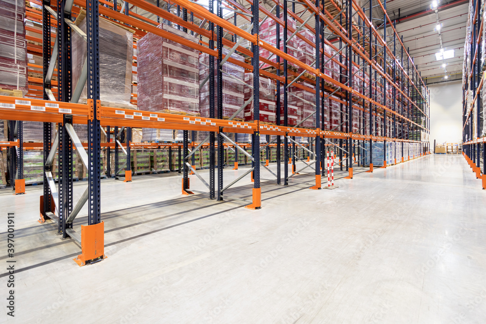 Tall racks alley in huge storage warehouse Stock Photo | Adobe Stock