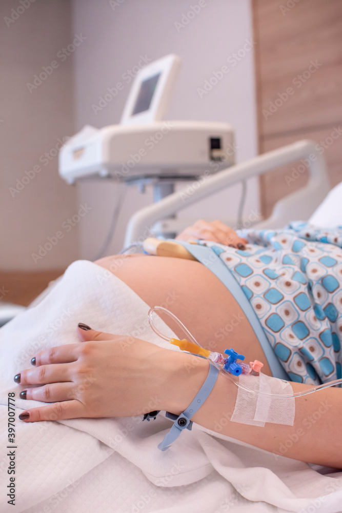 Pregnant woman in newborn hospital lying near fetal heart beat by fetal ...