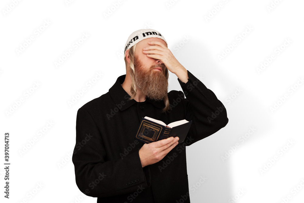 Religious Jewish man holding Siddur in his hand covering eyes with hand ...