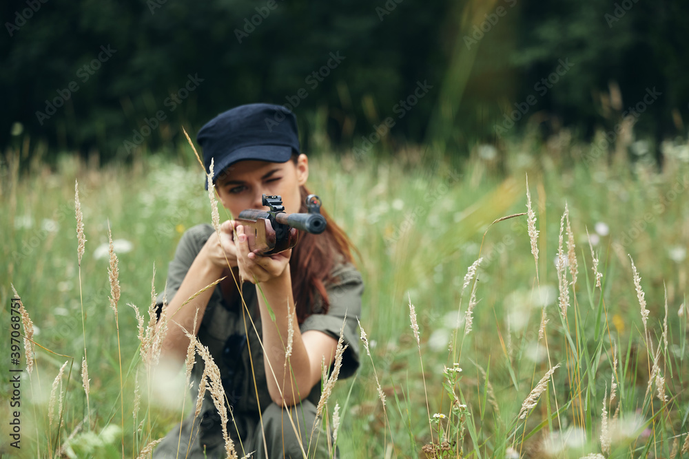 Military woman Take cover with a gun in hand green overalls Stock Photo ...