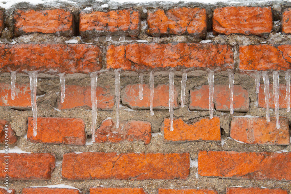 Melted snow and ice on a brick wall in spring. Stock Photo | Adobe Stock