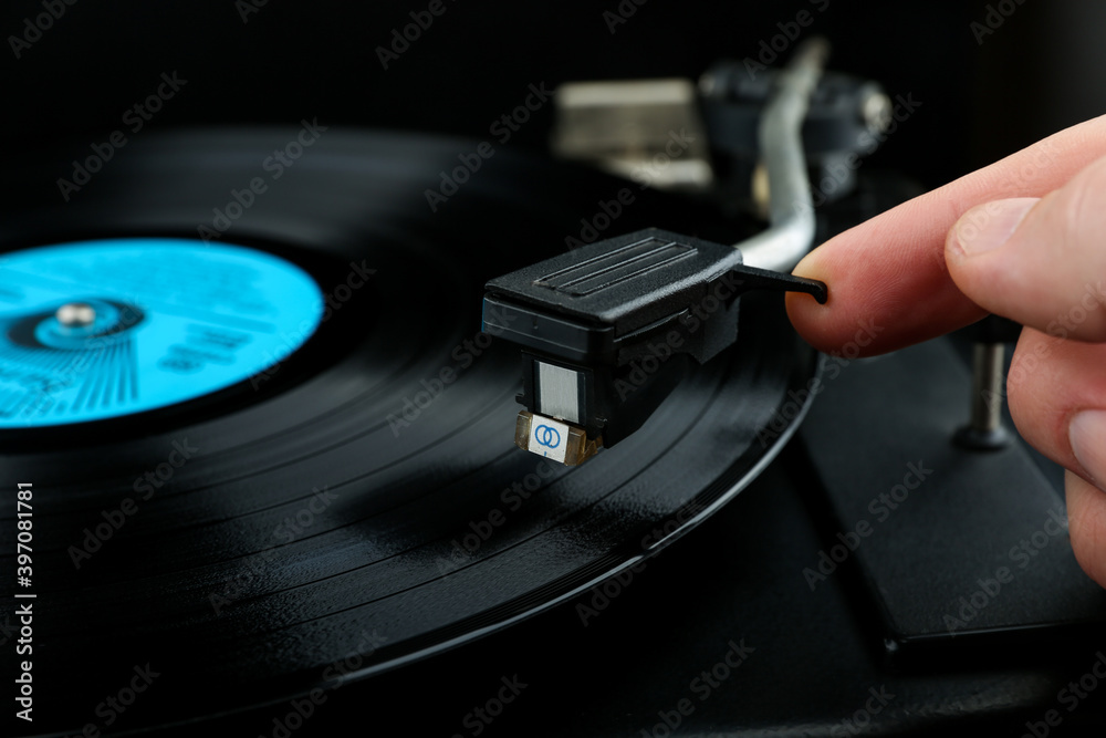 vinyl record on a turntable. turntable head close-up on black ...