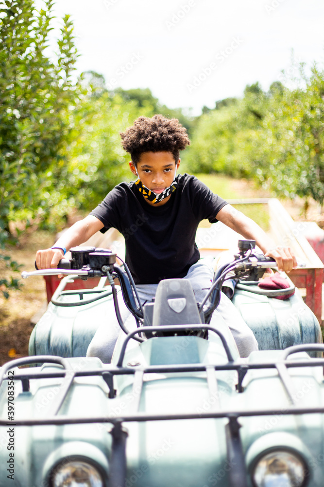 Preteen boy riding offroad ATV 4-wheeler Stock Photo | Adobe Stock