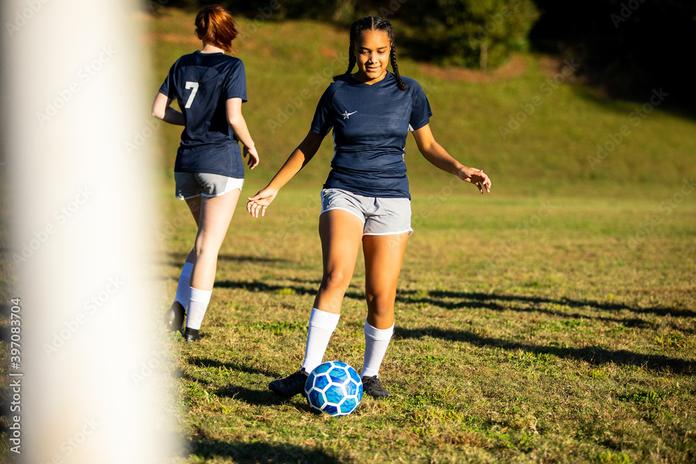 Soccer player running after ball Stock Photo | Adobe Stock