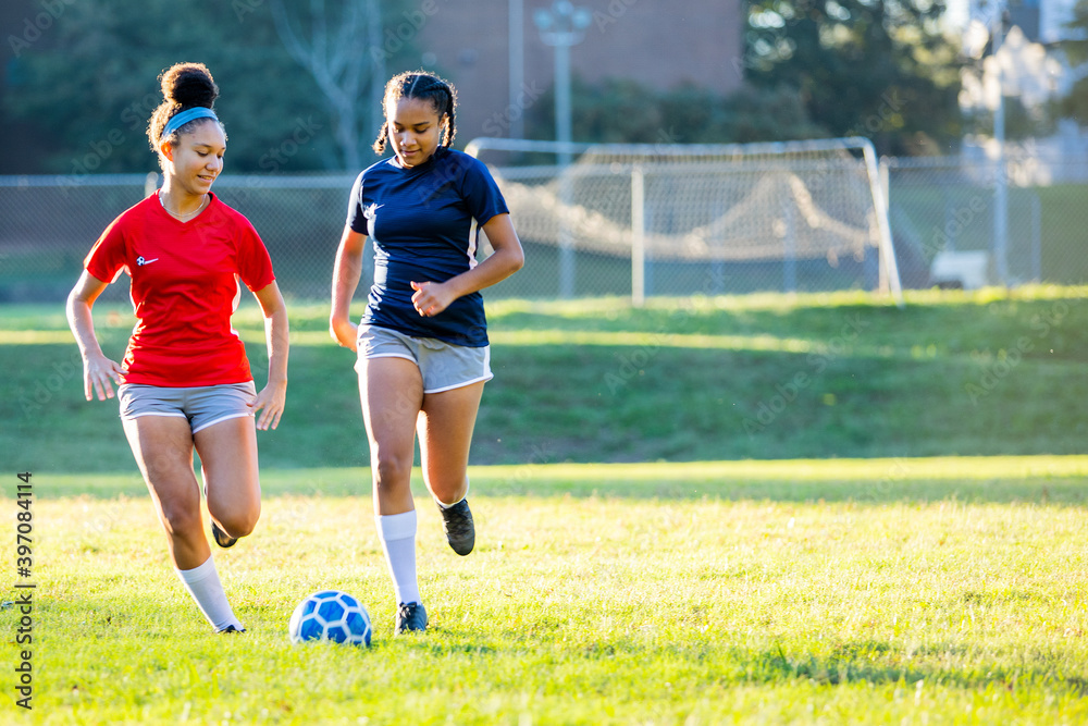 Teenage girl soccer players running after ball Stock Photo | Adobe Stock