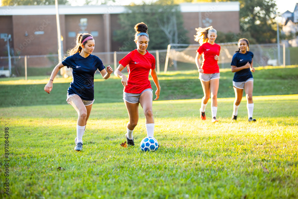 Teenage girl soccer players running after ball Stock Photo | Adobe Stock