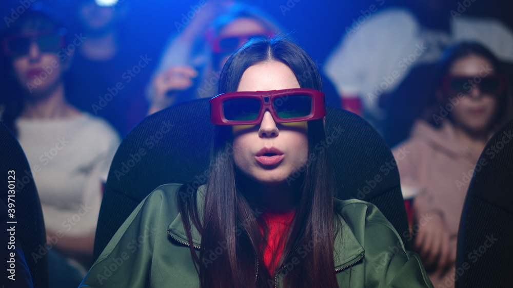 Frightened woman watching horror in cinema. Girl feeling scared in ...