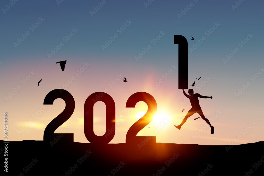 Silhouette man jumping and holding number 1 with birds flying on sunset ...