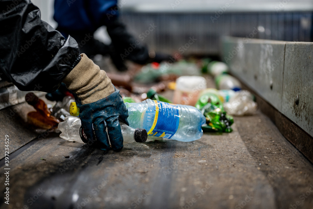 Manual waste bulkhead. Waste sorting plant conveyors filled with ...