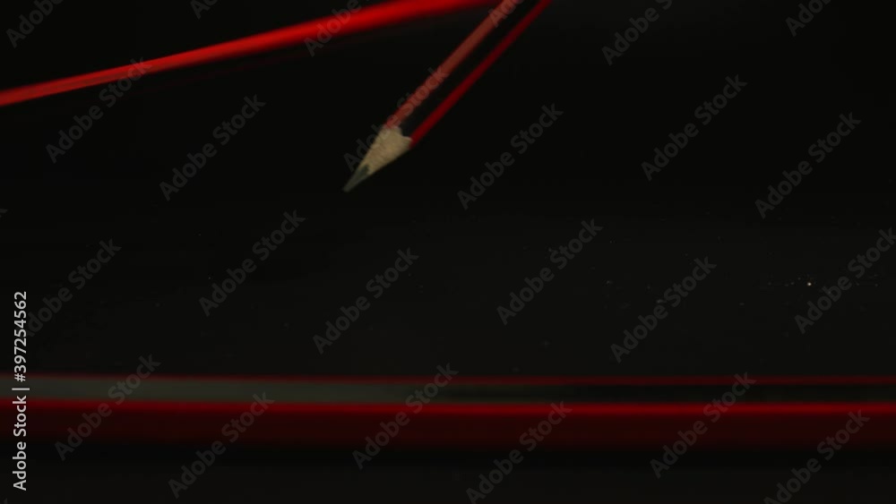 Pile of graphite pencils falling down on black table. Falling pencils ...