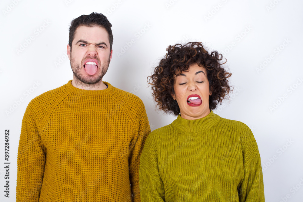 Body language. Disgusted stressed out Young couple wearing knitted ...