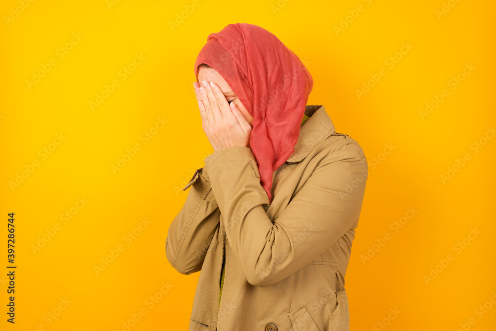 Sad MODEL covering face with hands and crying. Stock Photo | Adobe Stock