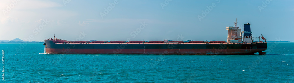 A large lightly loaded oil tanker sailing in the Singapore Straits in ...