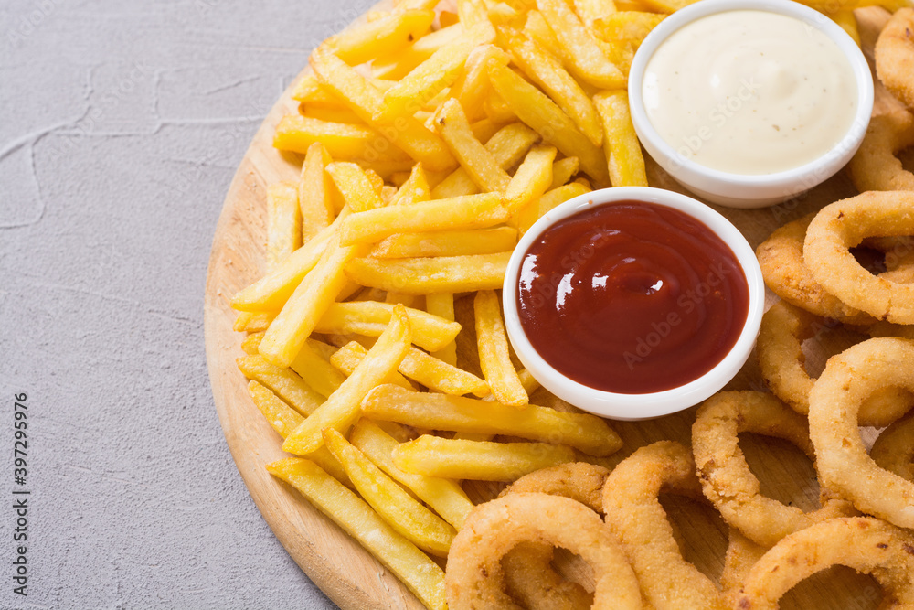 French fries and onion rings with sauces Stock Photo | Adobe Stock