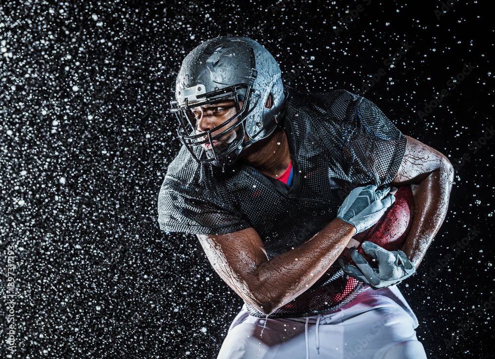 Water splashing on black football player Stock Photo | Adobe Stock