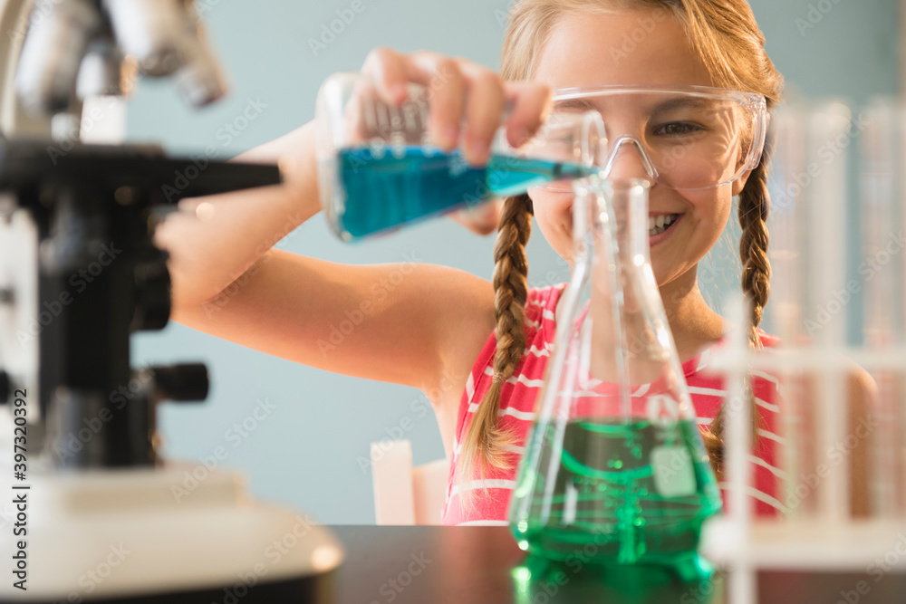 Caucasian girl doing science experiment in lab Stock Photo | Adobe Stock