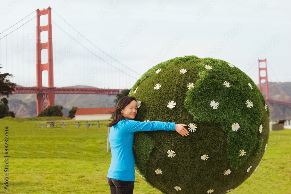 Chinese girl hugging earth topiary Stock Photo | Adobe Stock
