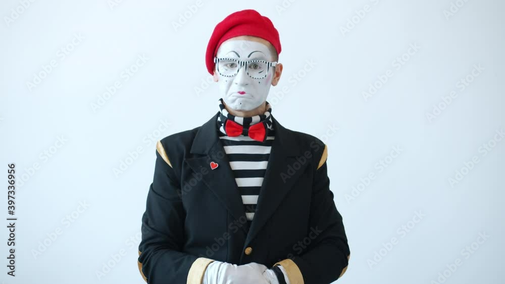 Portrait of mime shaking head then waving finger and pointing at screen ...