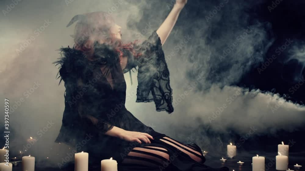 Candles placing around female demon, smoke rising. Woman dressing in ...