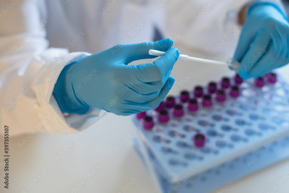Process of coronavirus testing examination by nurse medic in laboratory ...