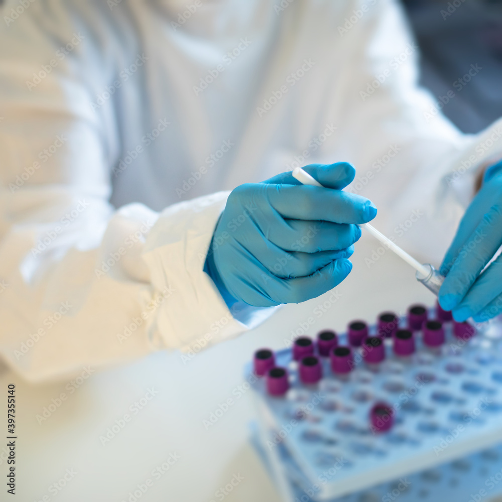 Process of coronavirus testing examination by nurse medic in laboratory ...