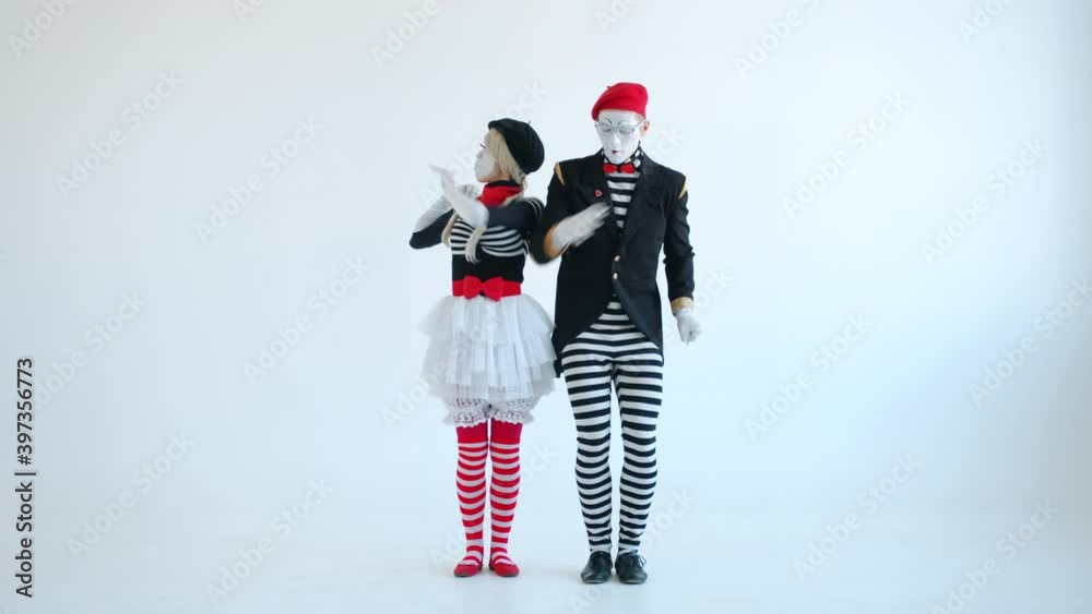 Man and woman mime actors are performing driving in car show on white ...