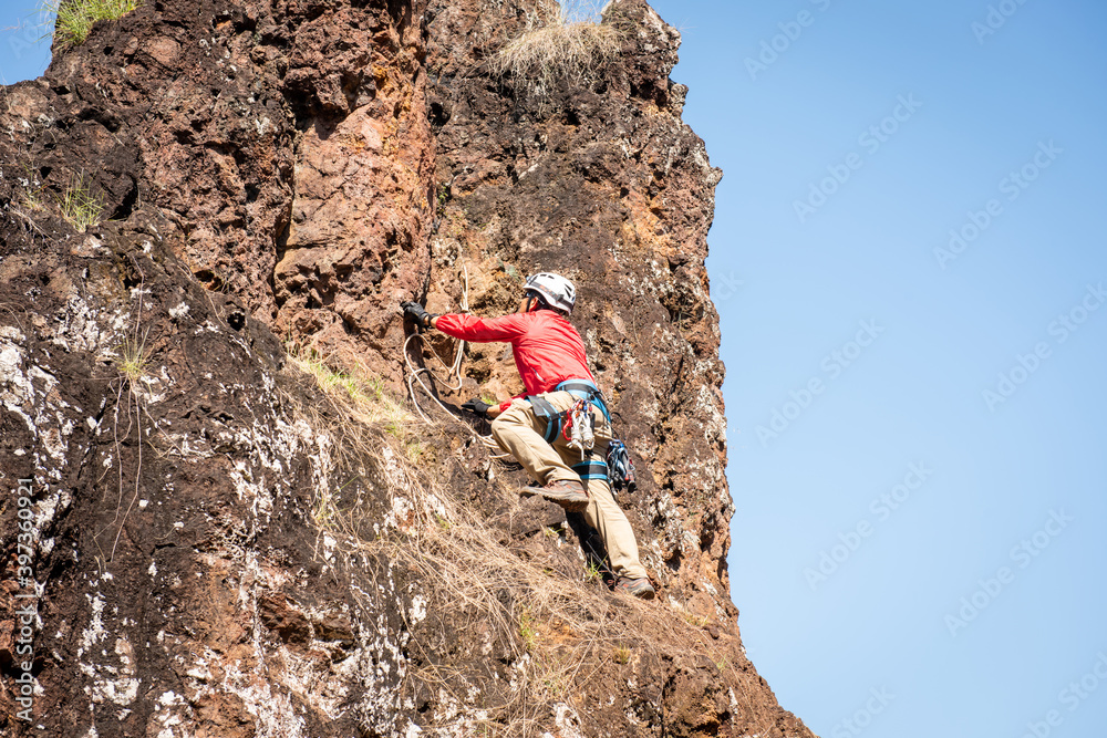 Rescuers or climber descends in a cave fast rope in the dark caves ...