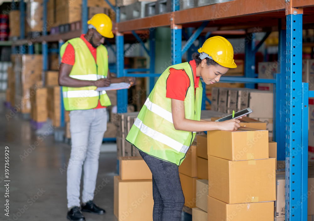 African American warehouse worker use tablet to check product in stock ...
