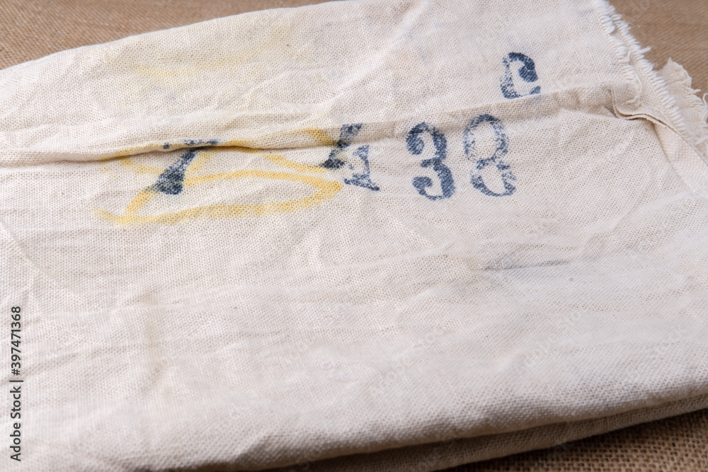 An old cloth bag for storing bulk grocery products. Dense material with ...