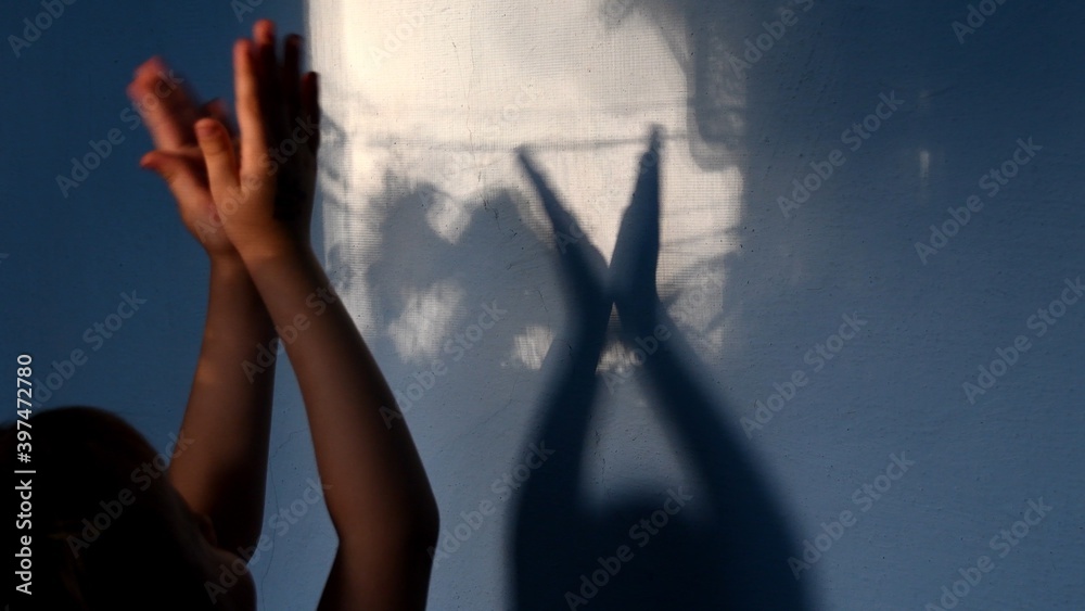 Child claps hands on unfocused foreground and focus to blurry hand ...
