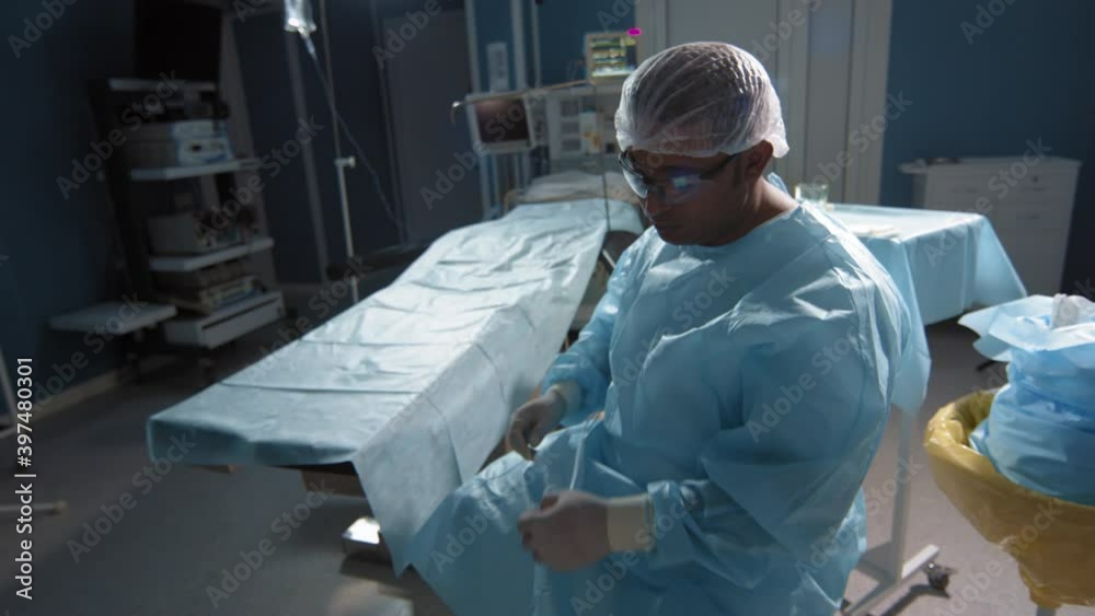 Medium slow-mo footage of sad male surgeon taking off mask after ...