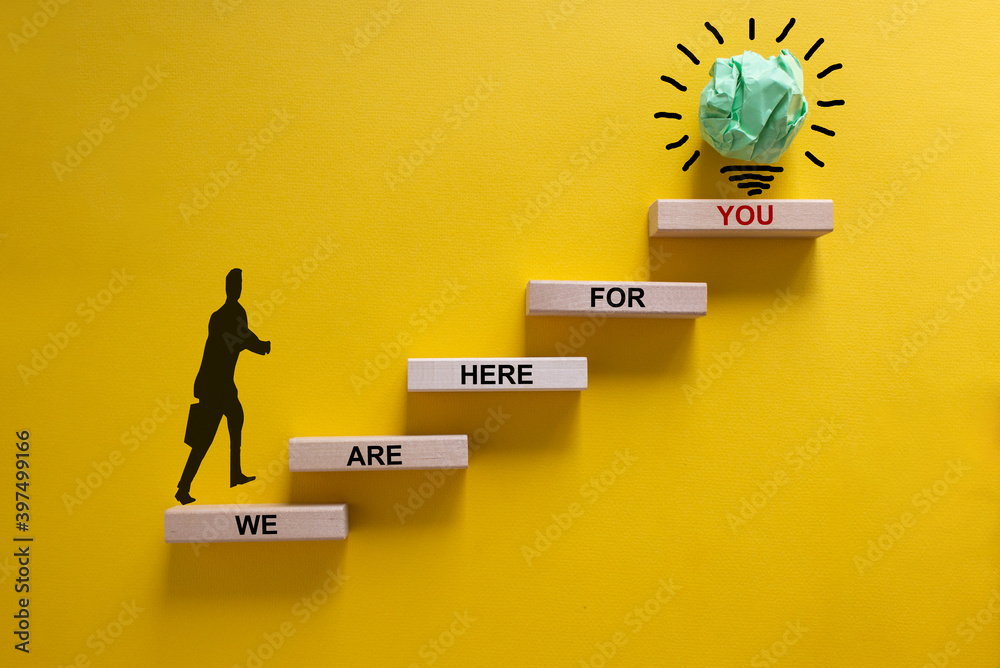 Support symbol. Wooden blocks with words 'we are here for you ...