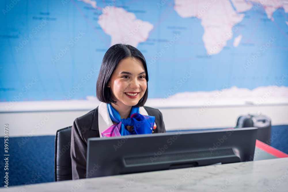 Gorgeous Asian airline ground staff smiles at the check-in counter at ...