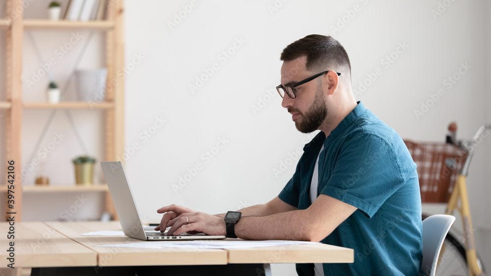 Wide banner panoramic view of concentrated young Caucasian male ...