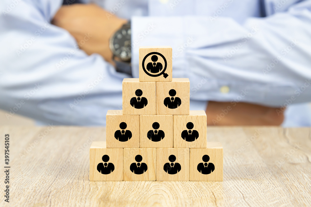 People icon on cube wooden toy blocks stacked in a pyramid shape ...