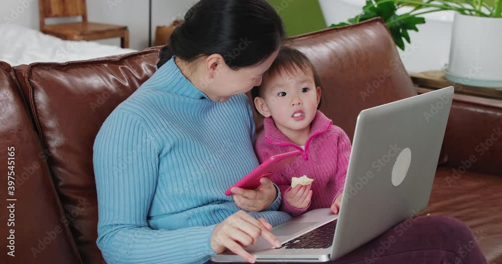 Happy asian woman suing laptop with baby girl sitting by lovely kid ...