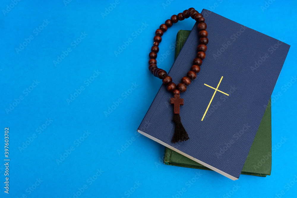 Religious literature and freedom of religion. Brown wooden rosary on ...
