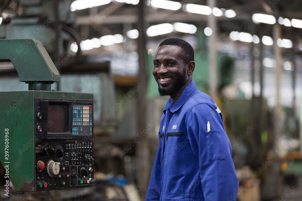 Smiling black male engineer at work in the industrial factory. African ...